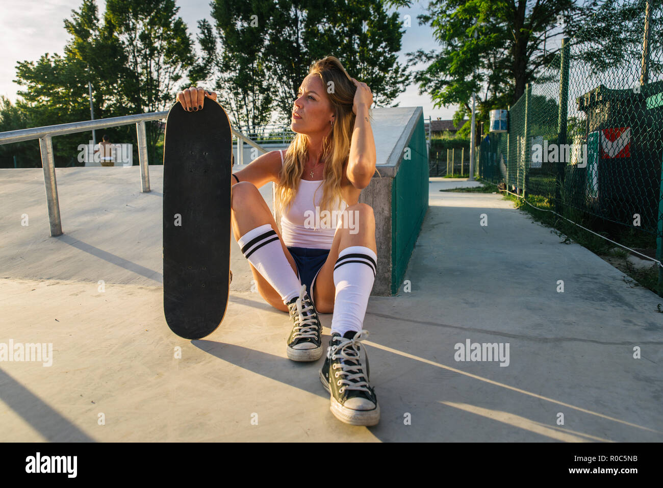 Stylish young woman skating outdoors - Pretty female skater playing ...