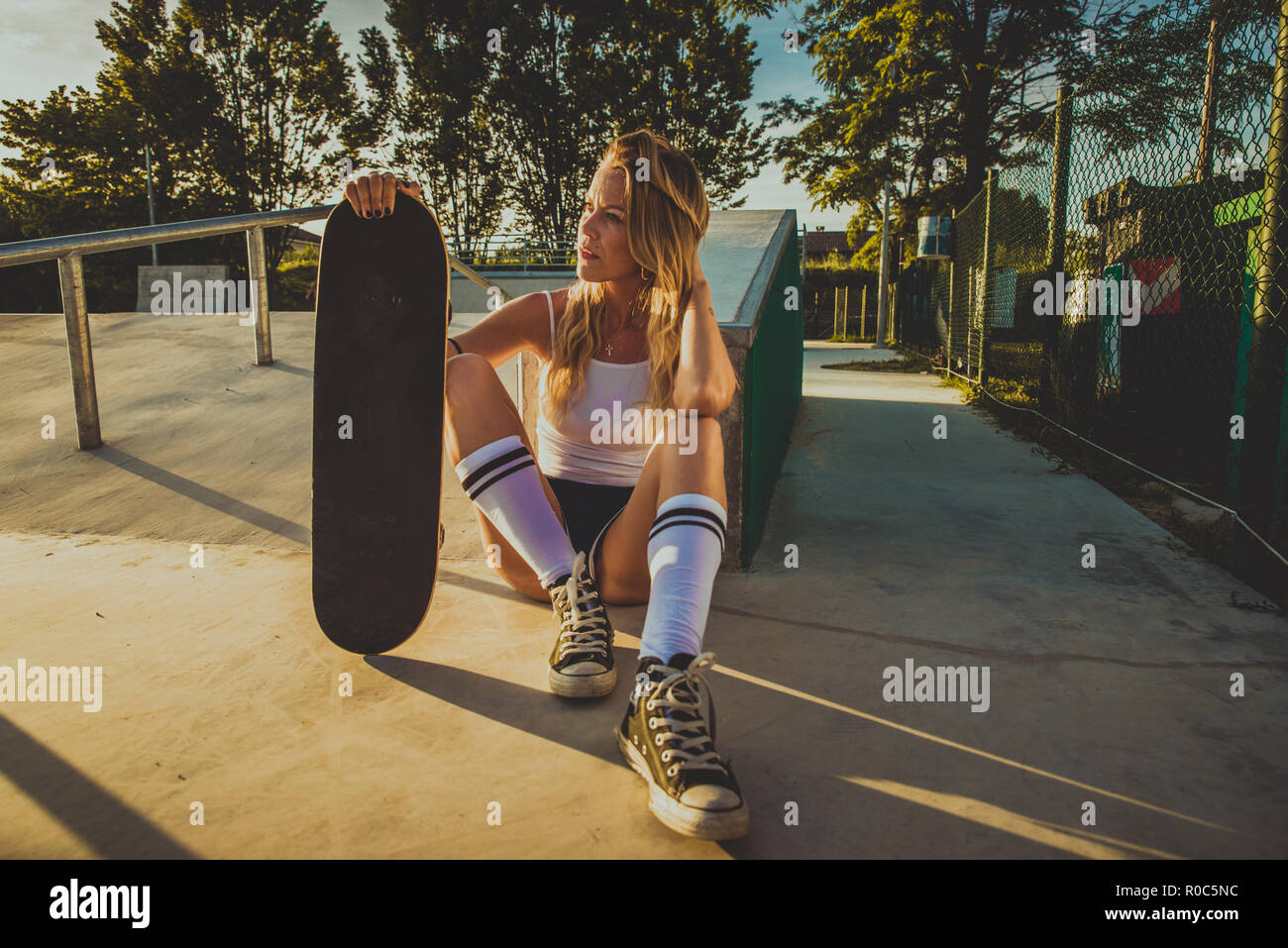 Stylish young woman skating outdoors - Pretty female skater playing ...