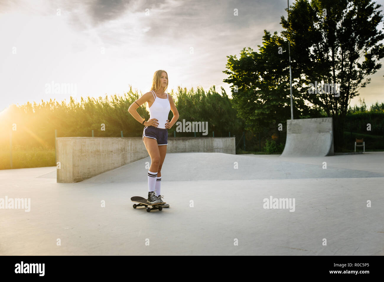 Stylish young woman skating outdoors - Pretty female skater playing ...