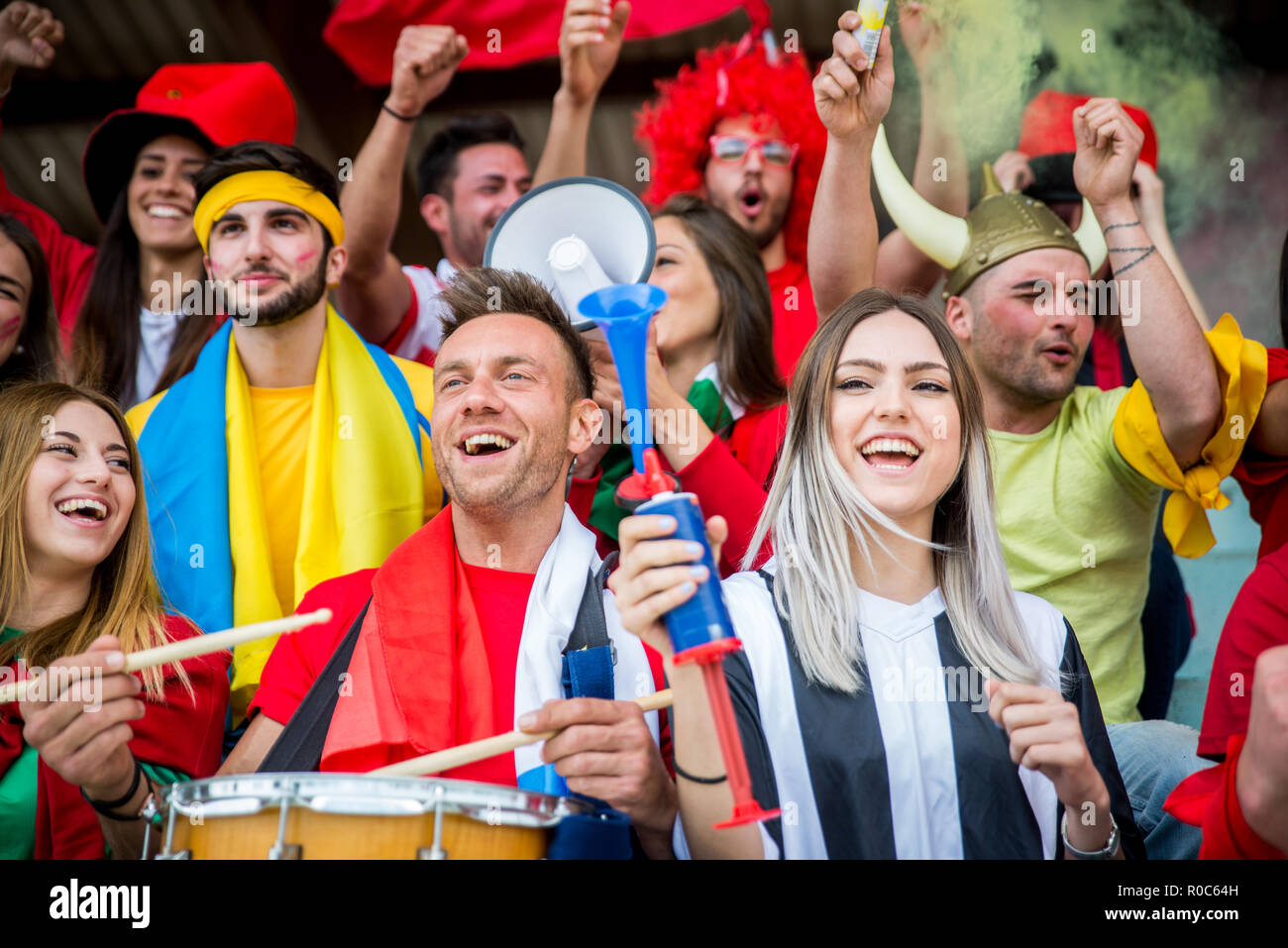Football supporters at the stadium - Football fans having fun and ...