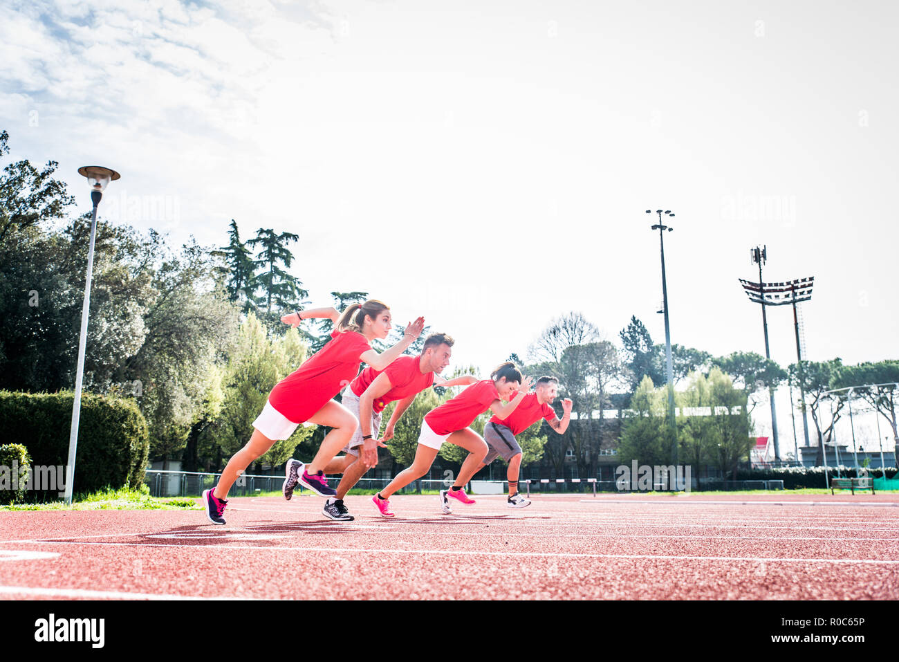 Group of athletes sprinting on a runner track Stock Photo - Alamy
