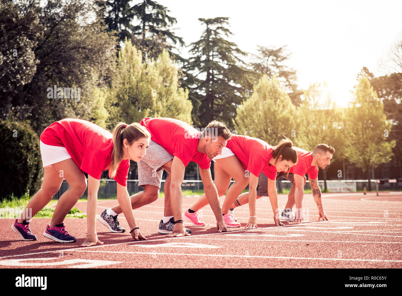 Group of athletes sprinting on a runner track Stock Photo - Alamy