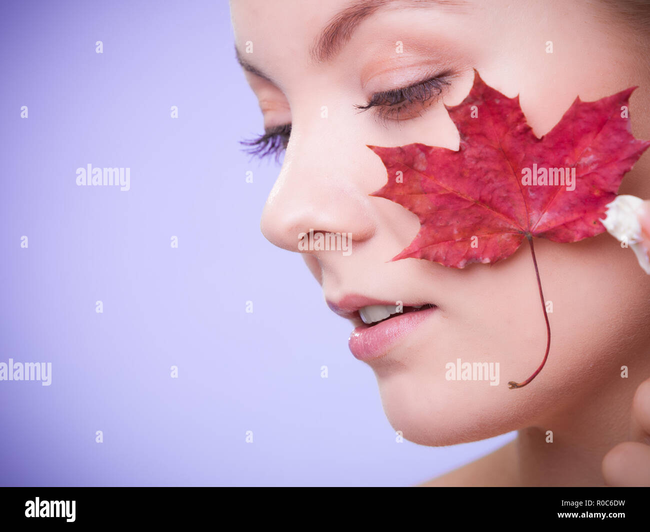 Skincare habits. Face of young woman with leaf as symbol of red ...