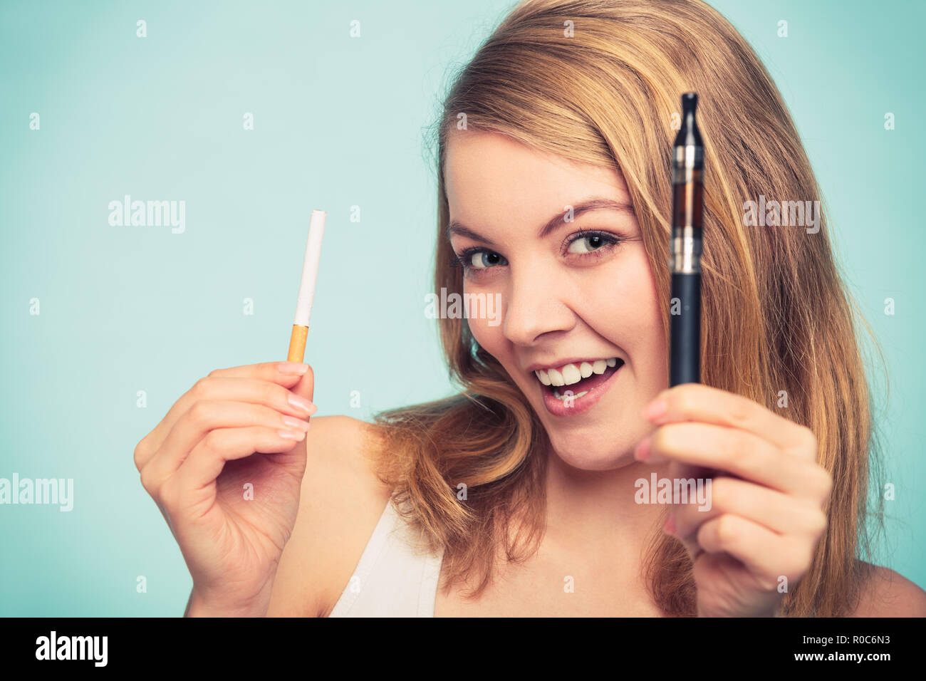 Pretty girl smoking normal and electronic cigarette. Addicted nicotine ...