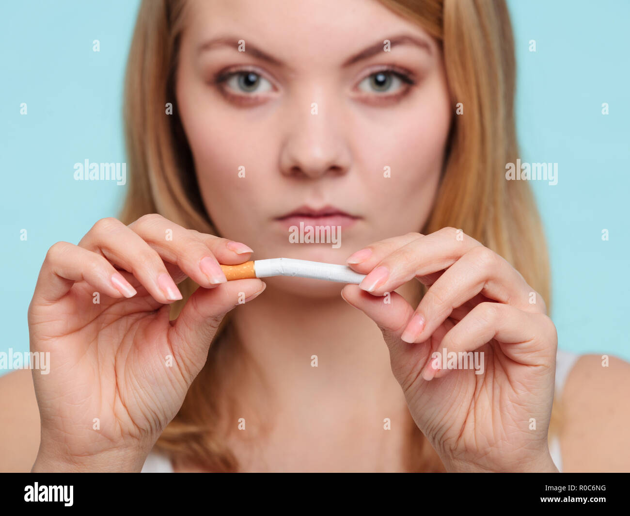 Pretty girl breaking up with cigarette. Addicted nicotine problems in ...