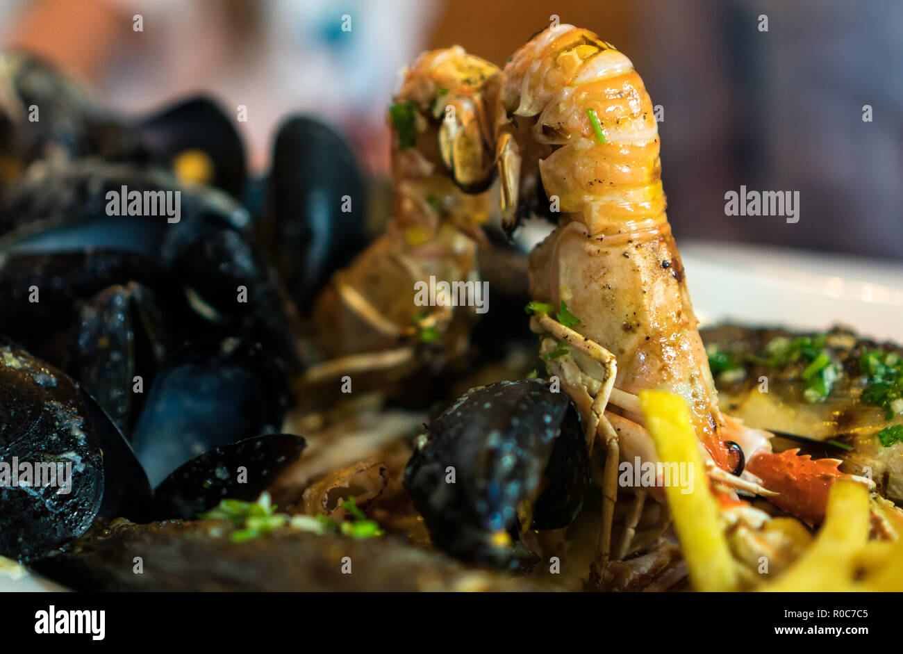 Seafood plate in restaurant. King shrimps and mussels Stock Photo - Alamy