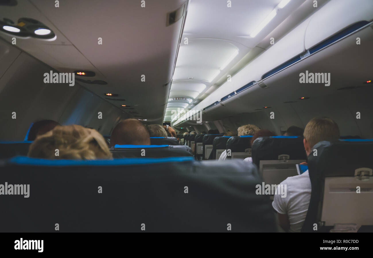 Interior inside of the plane with passengers Stock Photo - Alamy
