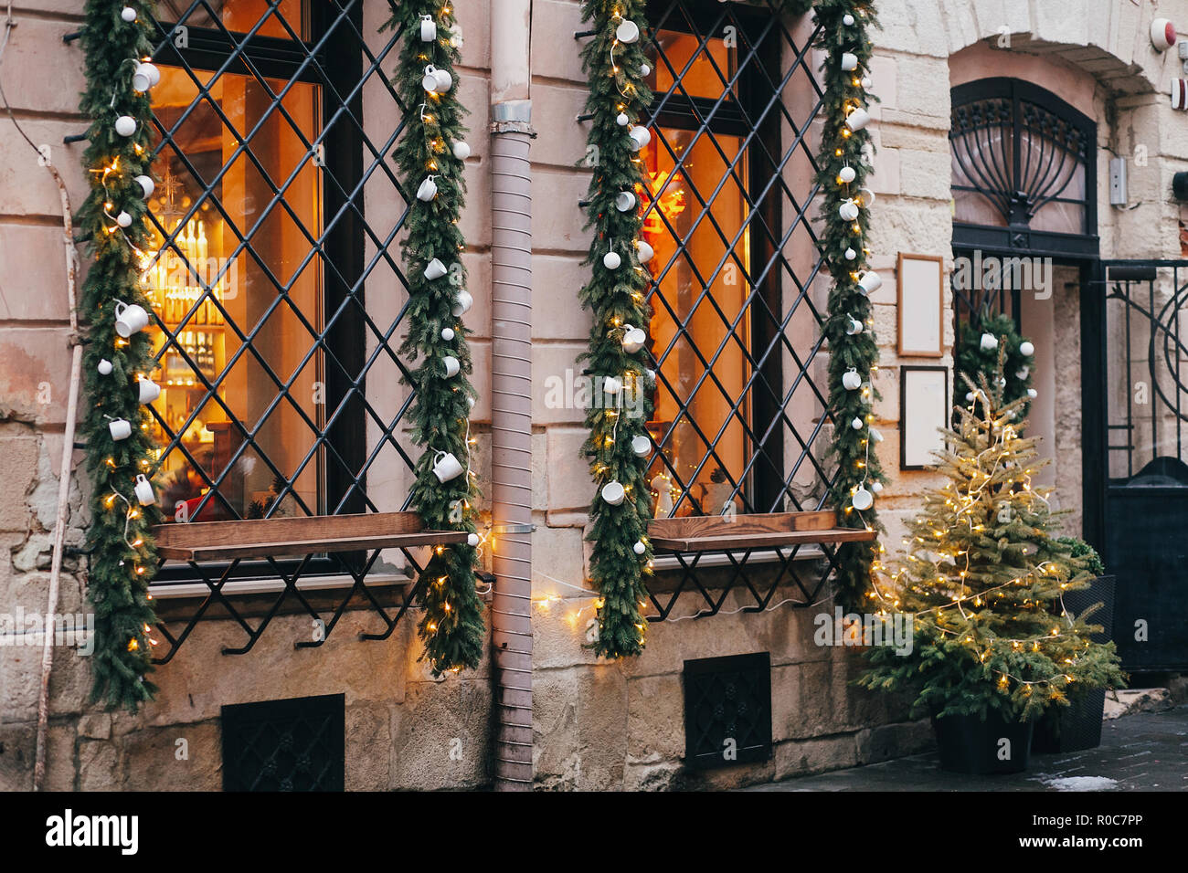 Stylish christmas decorations, white ceramics cups of coffee or tea ...
