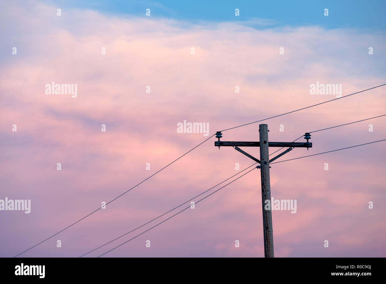 Telegraph pole and wires at sunset Stock Photo - Alamy