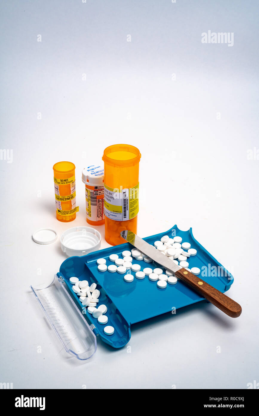 Prescription medication is laid out on a pharmacists counting tray ...