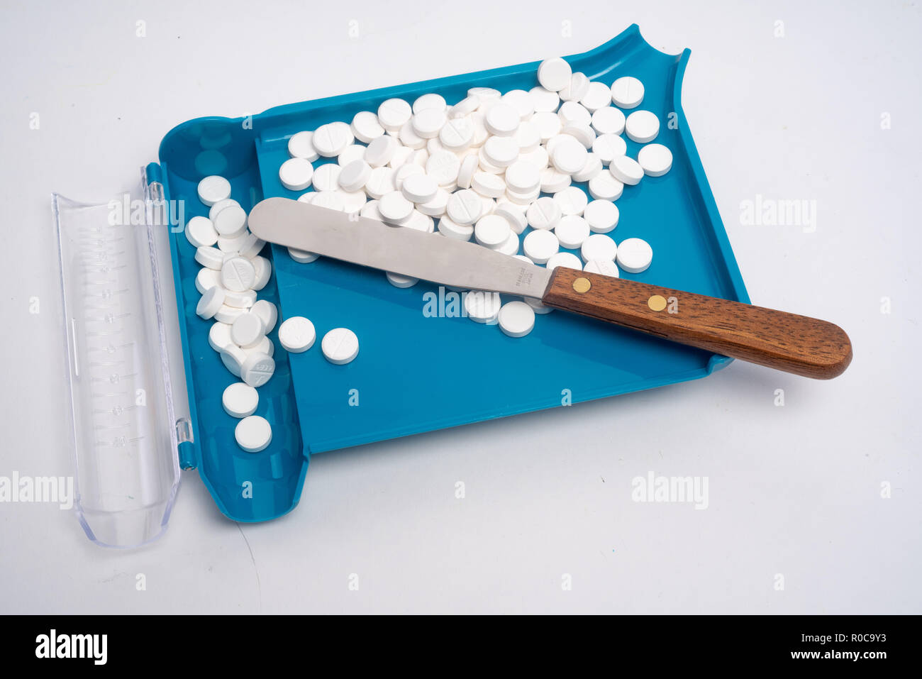 Prescription medication is laid out on a pharmacists counting tray ...