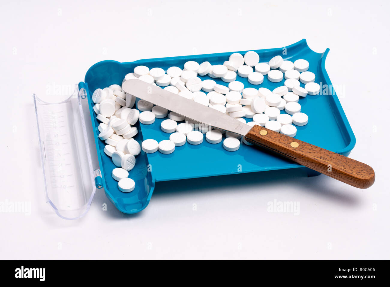 Prescription medication is laid out on a pharmacists counting tray ...