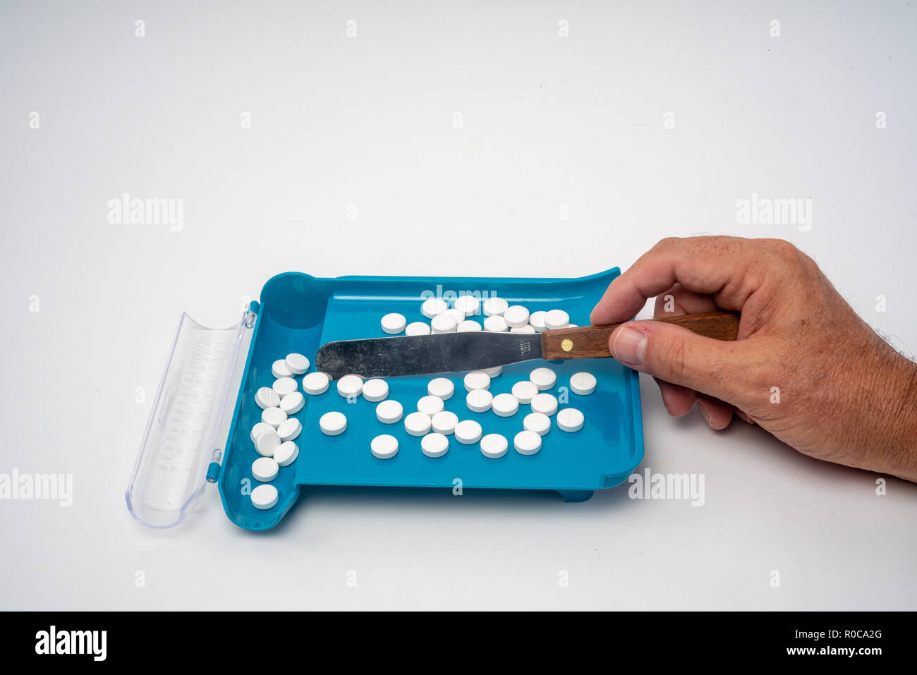 Prescription medication is laid out on a pharmacists counting tray ...