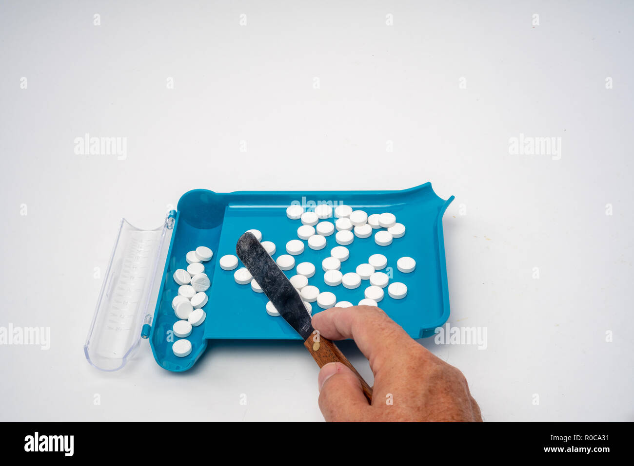 Prescription medication is laid out on a pharmacists counting tray ...