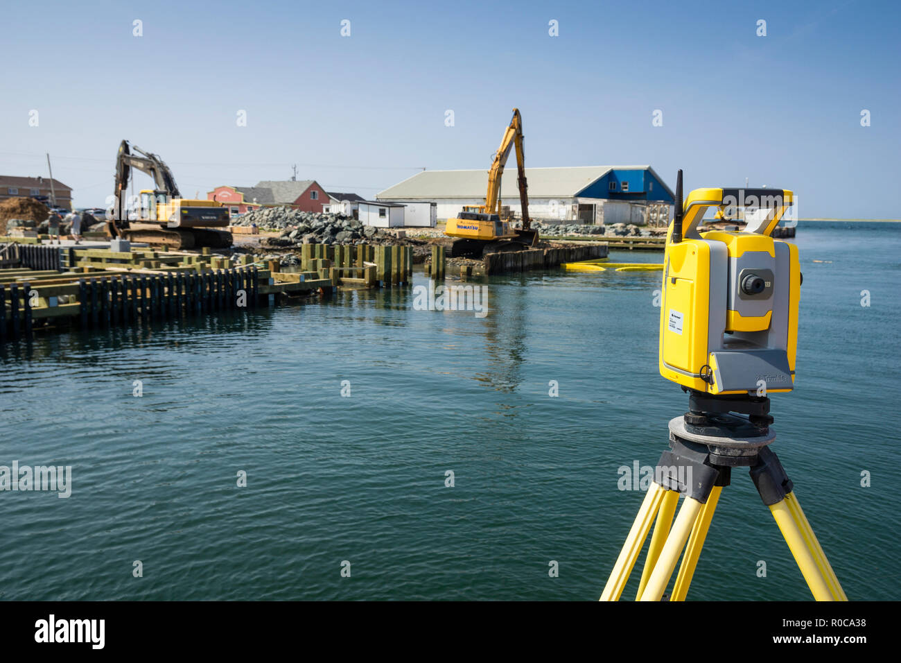 Tripod-mounted Trimble total station surveying instrument used in wharf ...