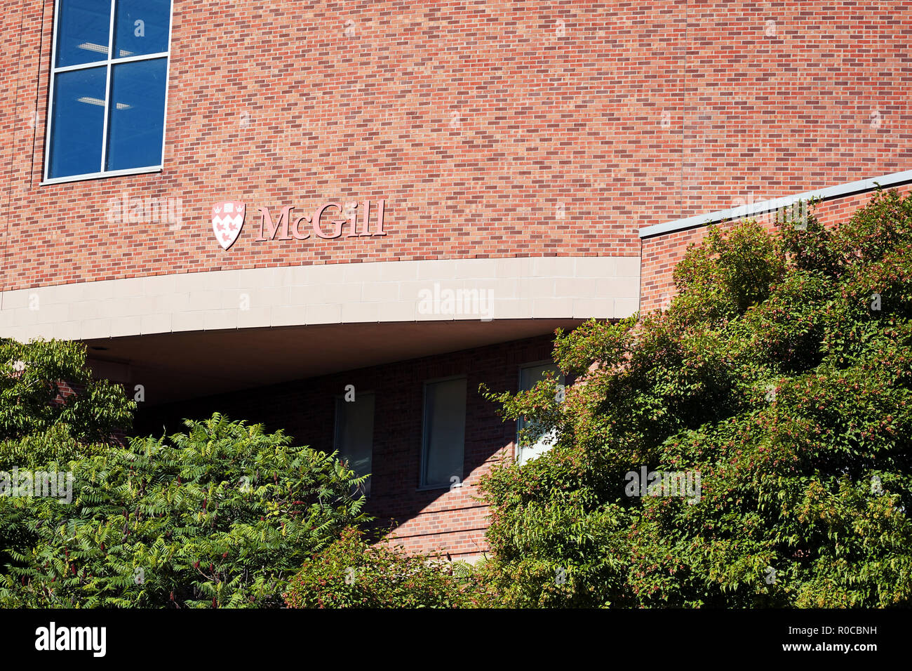 Exterior view of Mc Gill university brick building and the logo in ...