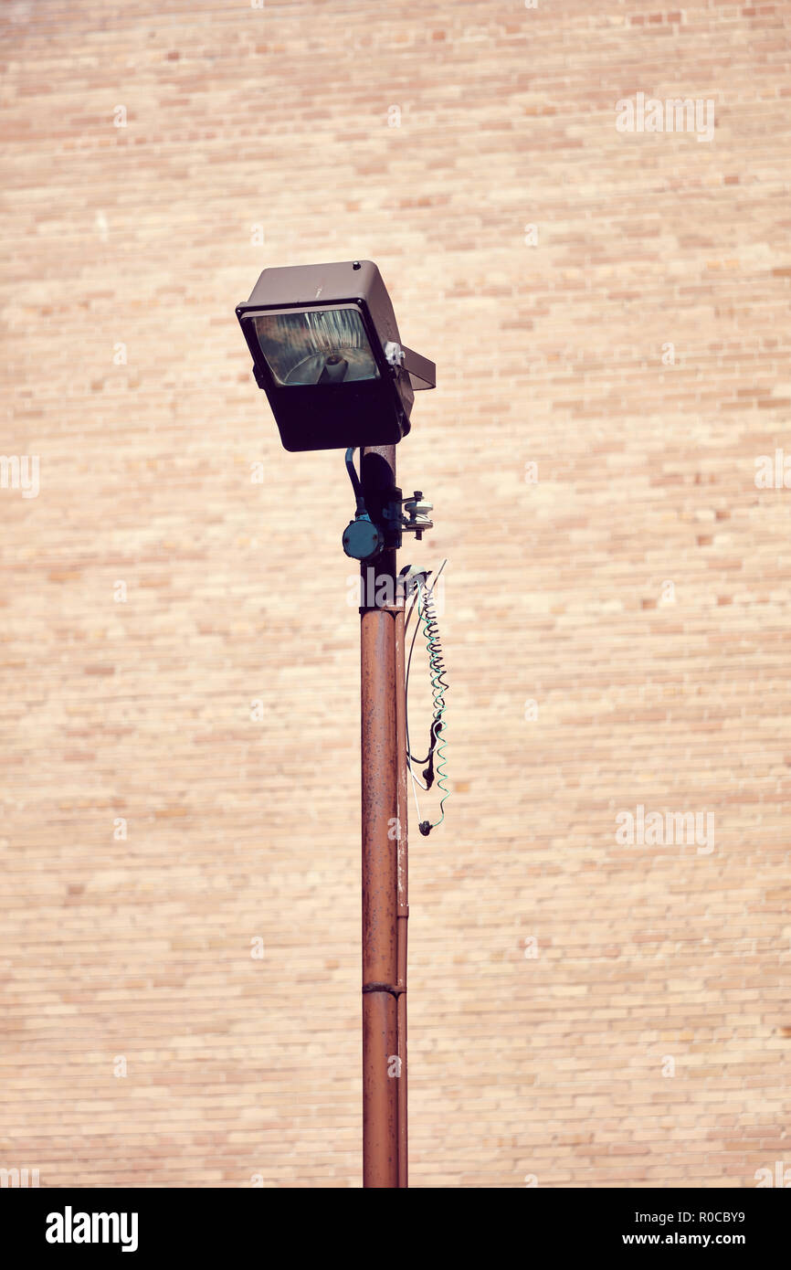 Retro rusty street lamp post on brick wall background Stock Photo - Alamy