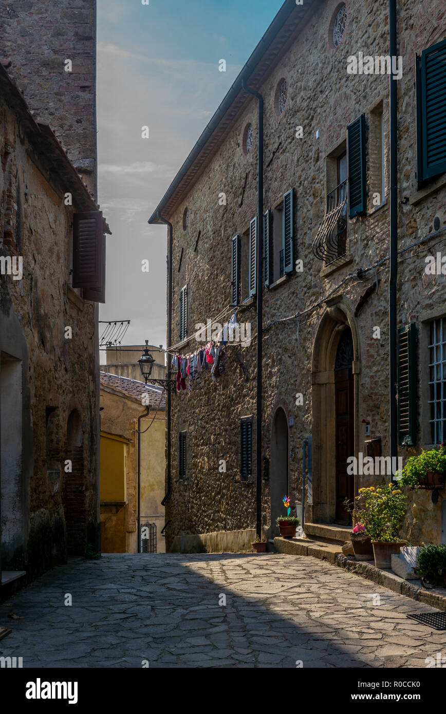 Colorful narrow streets in the medieval town of Guardistallo in Tuscany ...