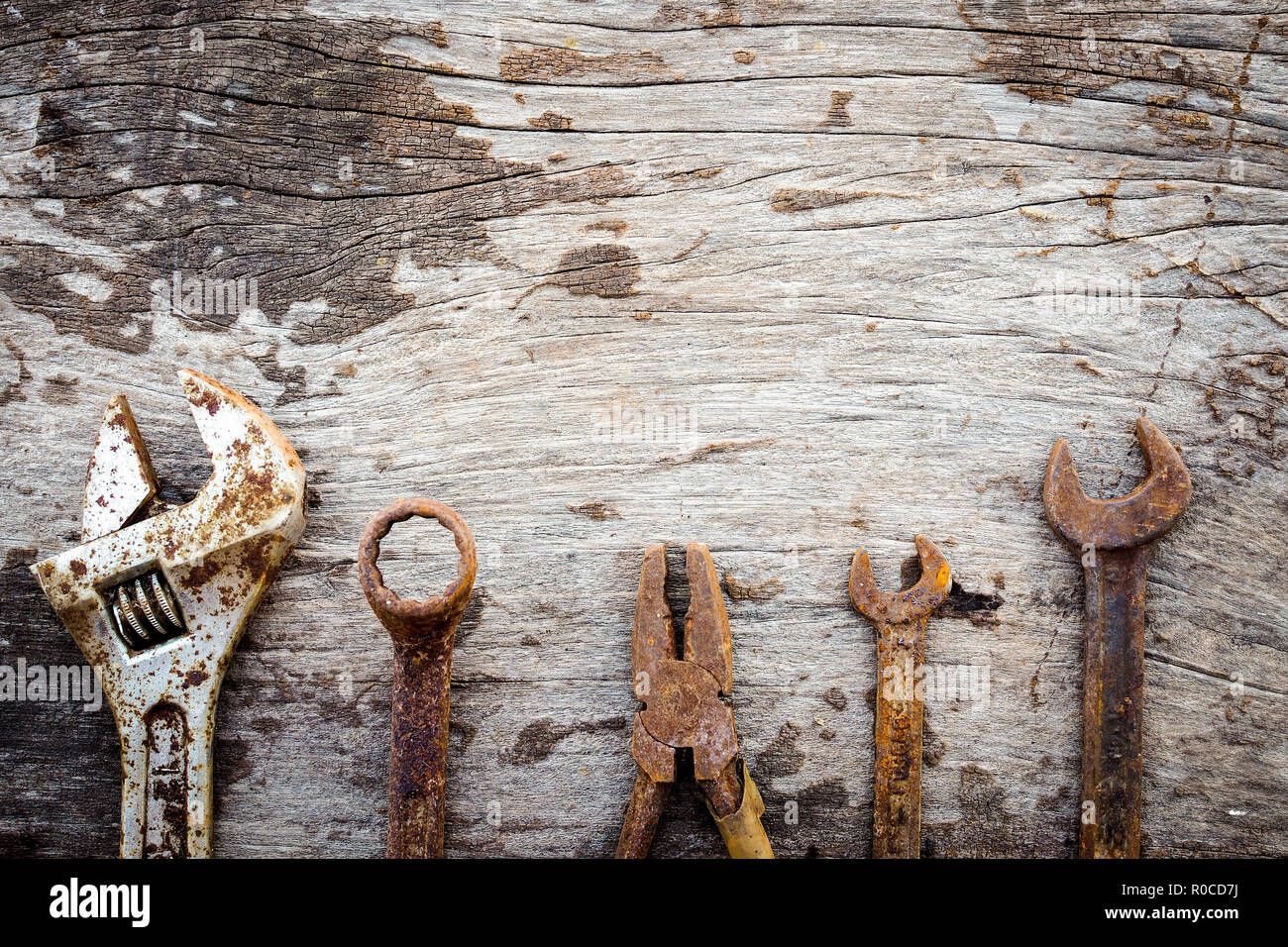 Old rusty tools on wooden background. vintage styles Stock Photo - Alamy