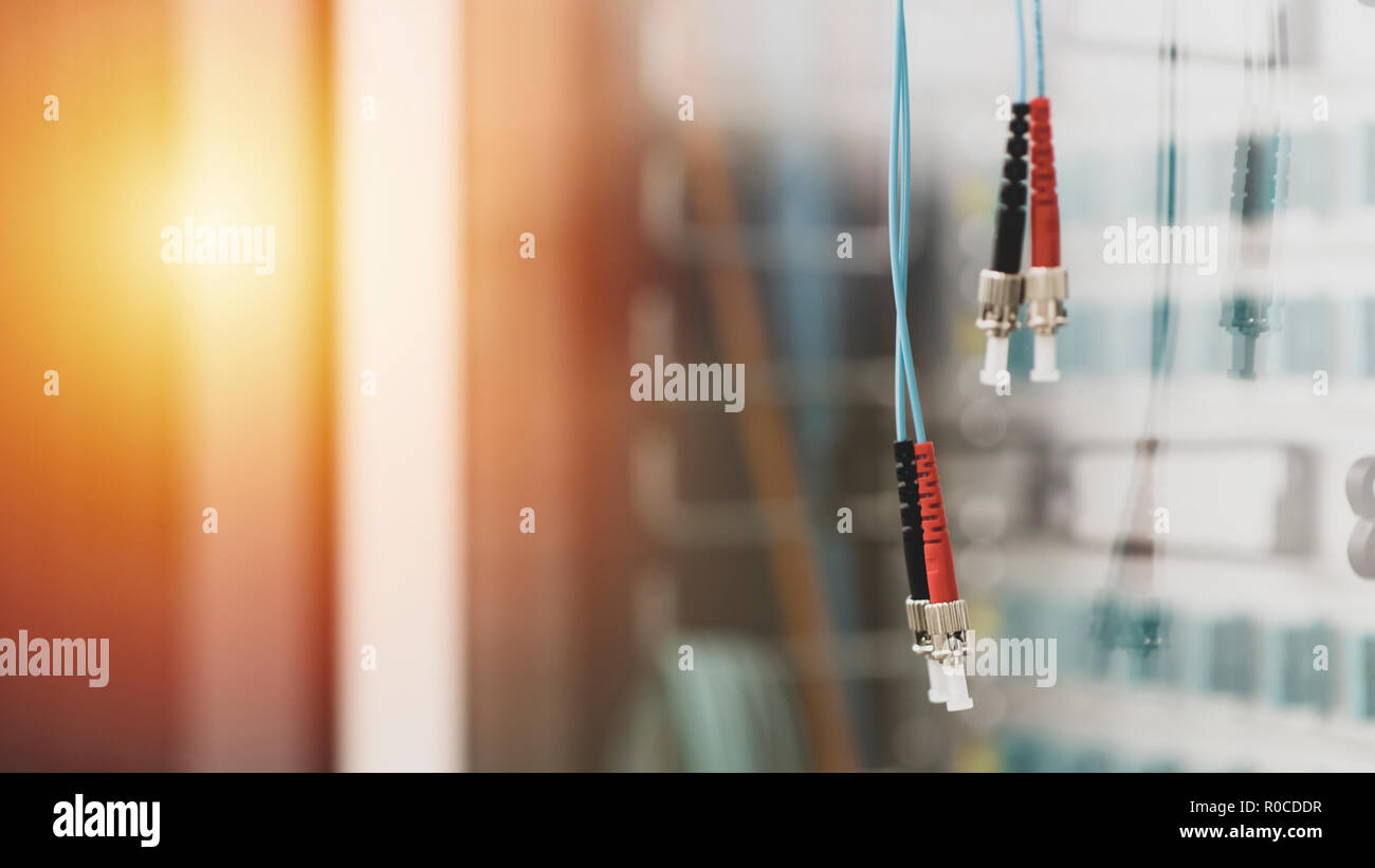 Pair of fiber optic cables with FC type connectors in server room ...