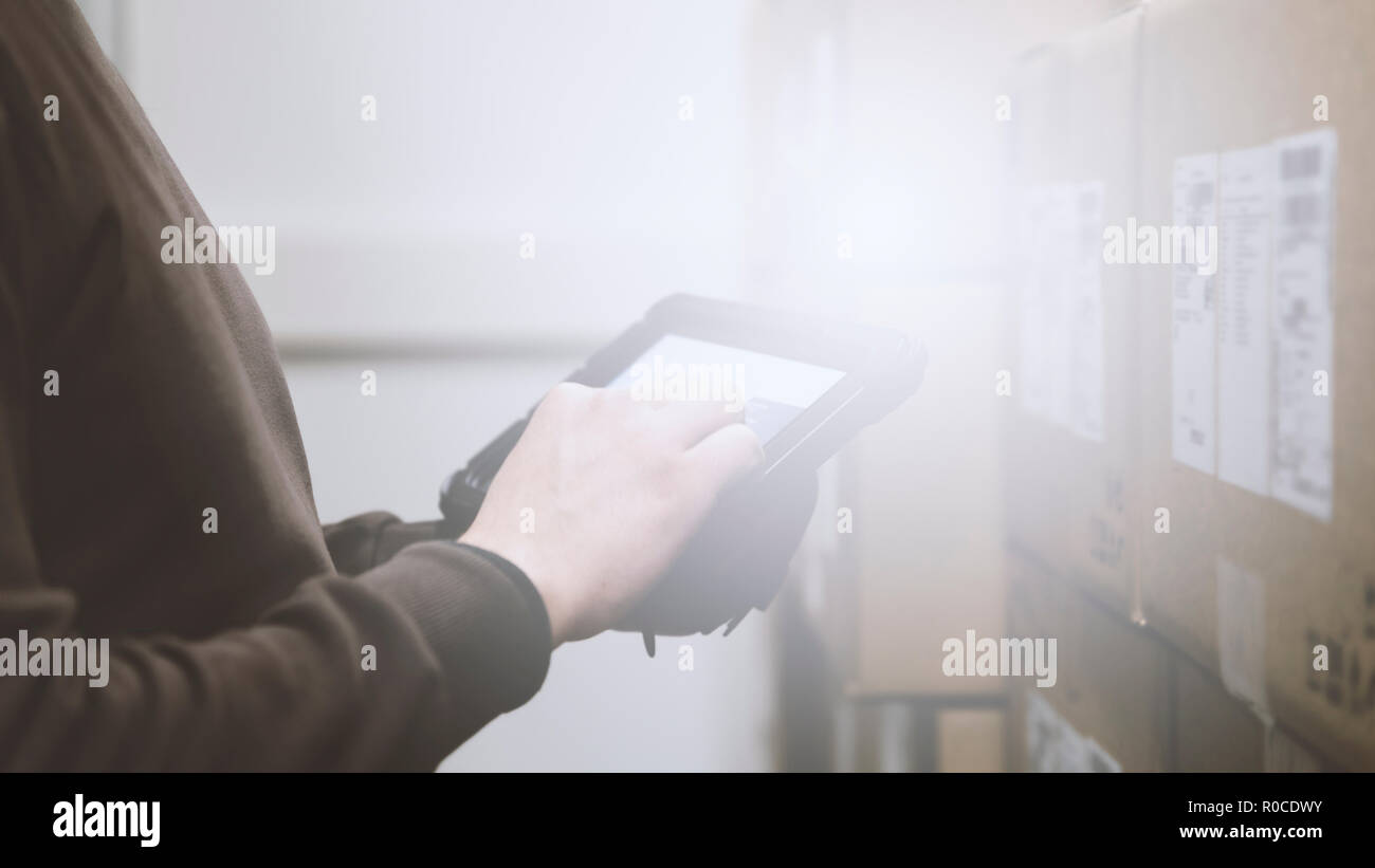 Inventory of the goods in the warehouse, employee with tablet checks ...