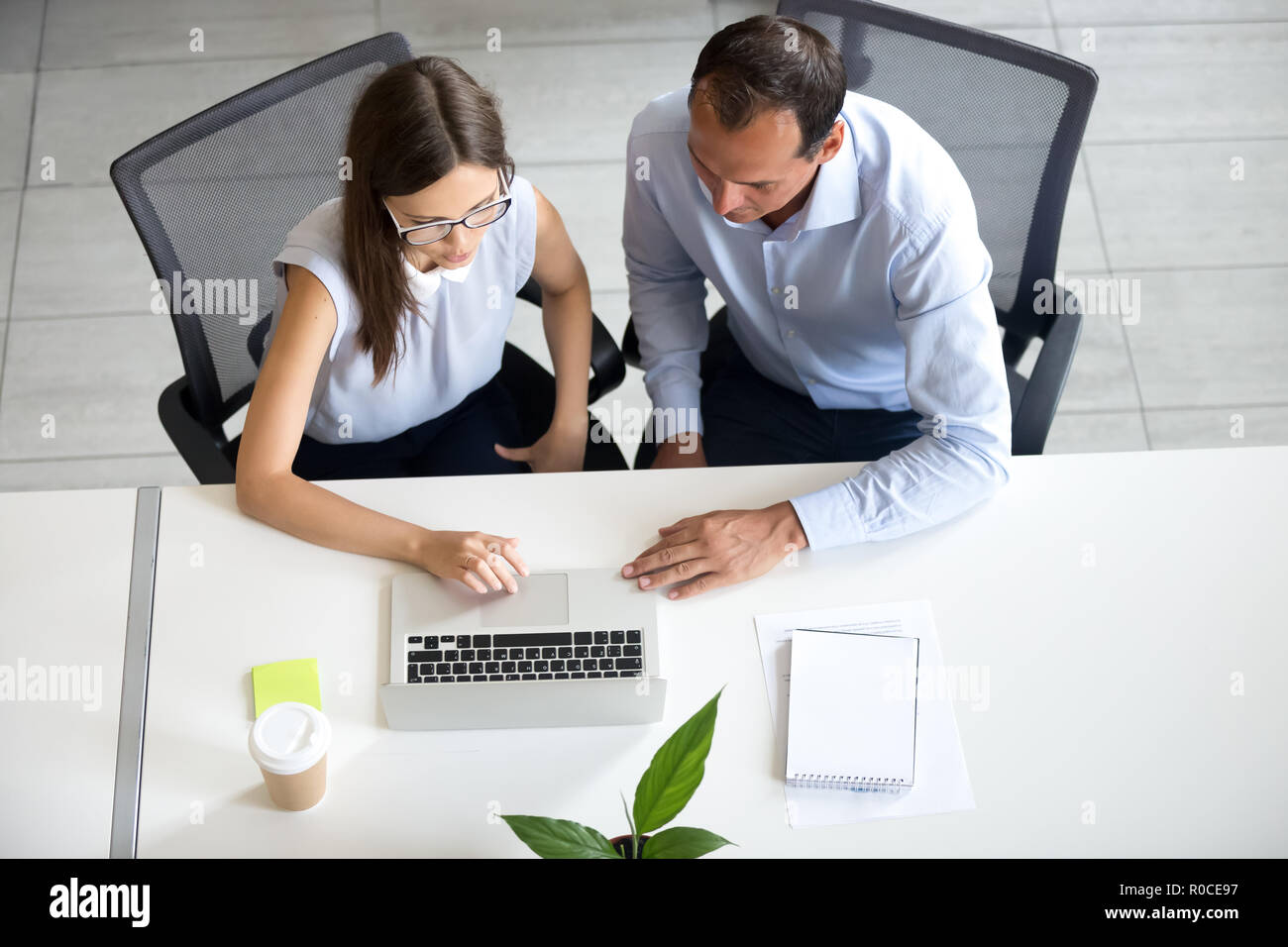 Office workers discussing project working together using laptop Stock ...