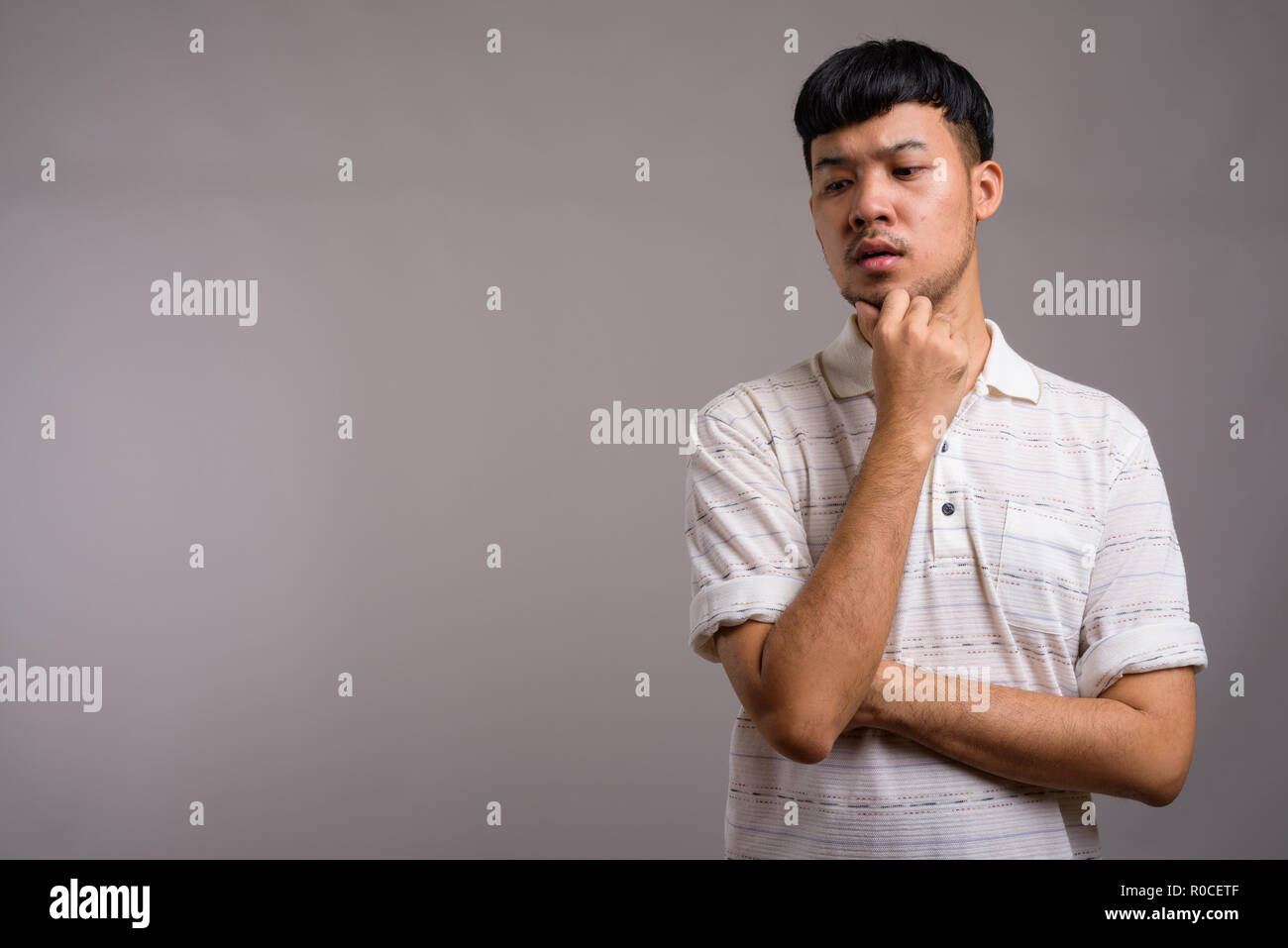 Portrait of young Asian man thinking and planning Stock Photo - Alamy