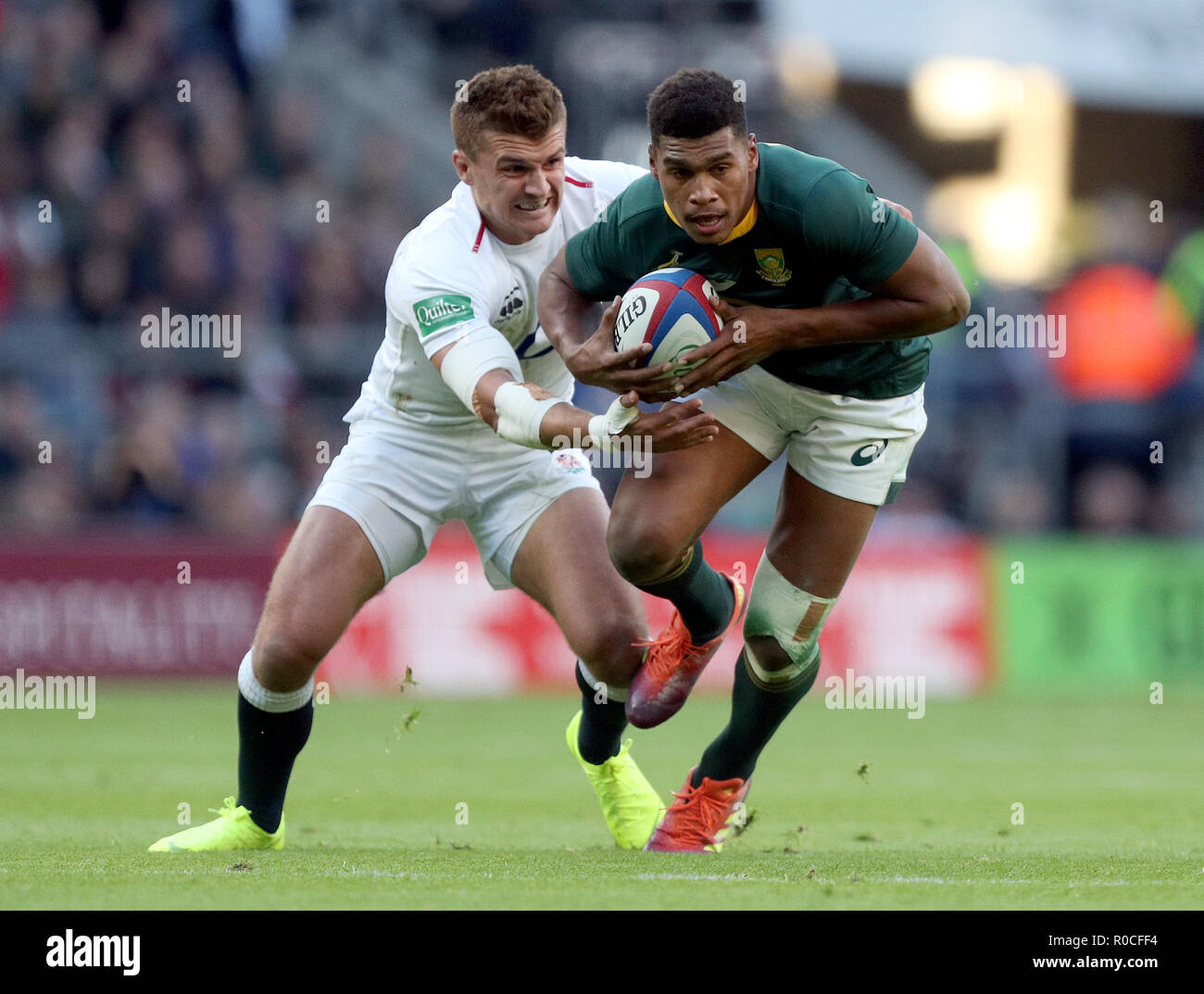South Africa's Damian Willemse (right) gets away from England's Henry ...