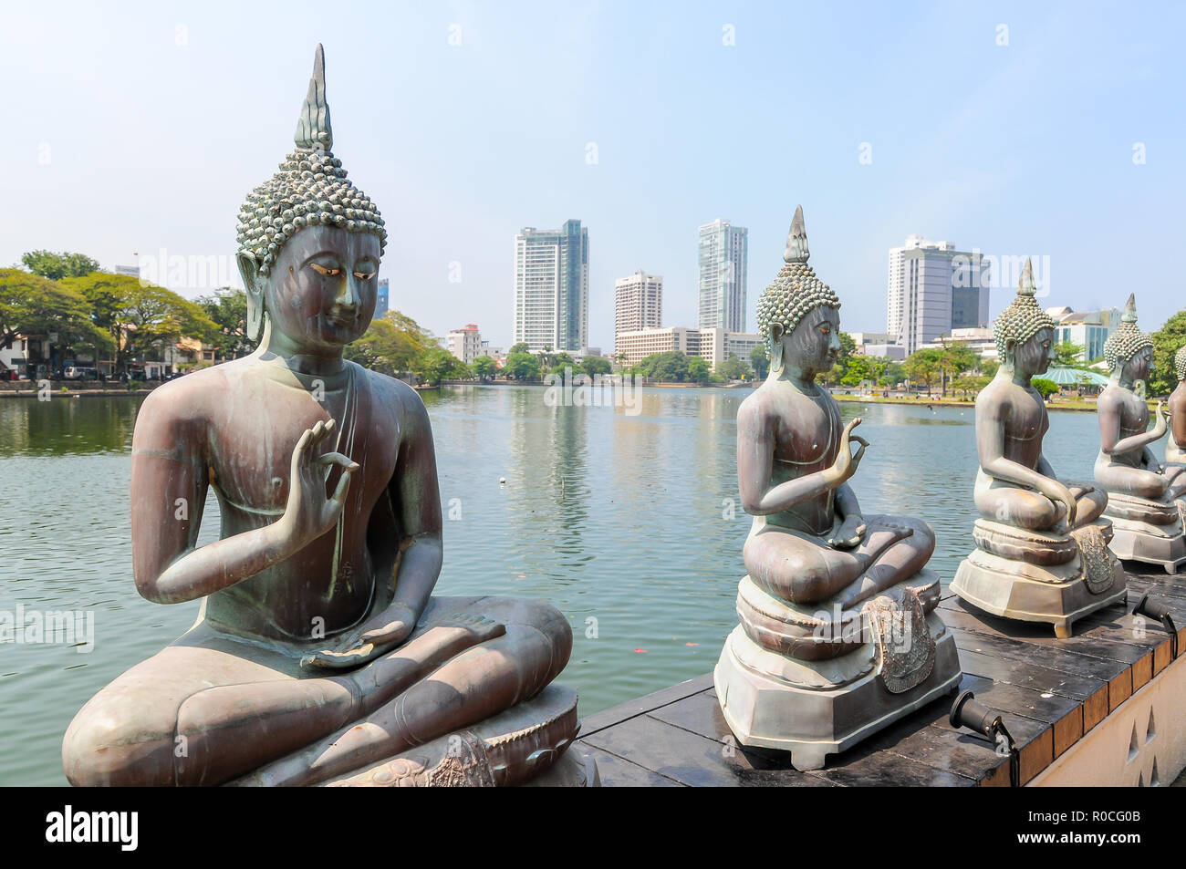 Buddha statues in the center of Colombo, in the background skyscrapers ...