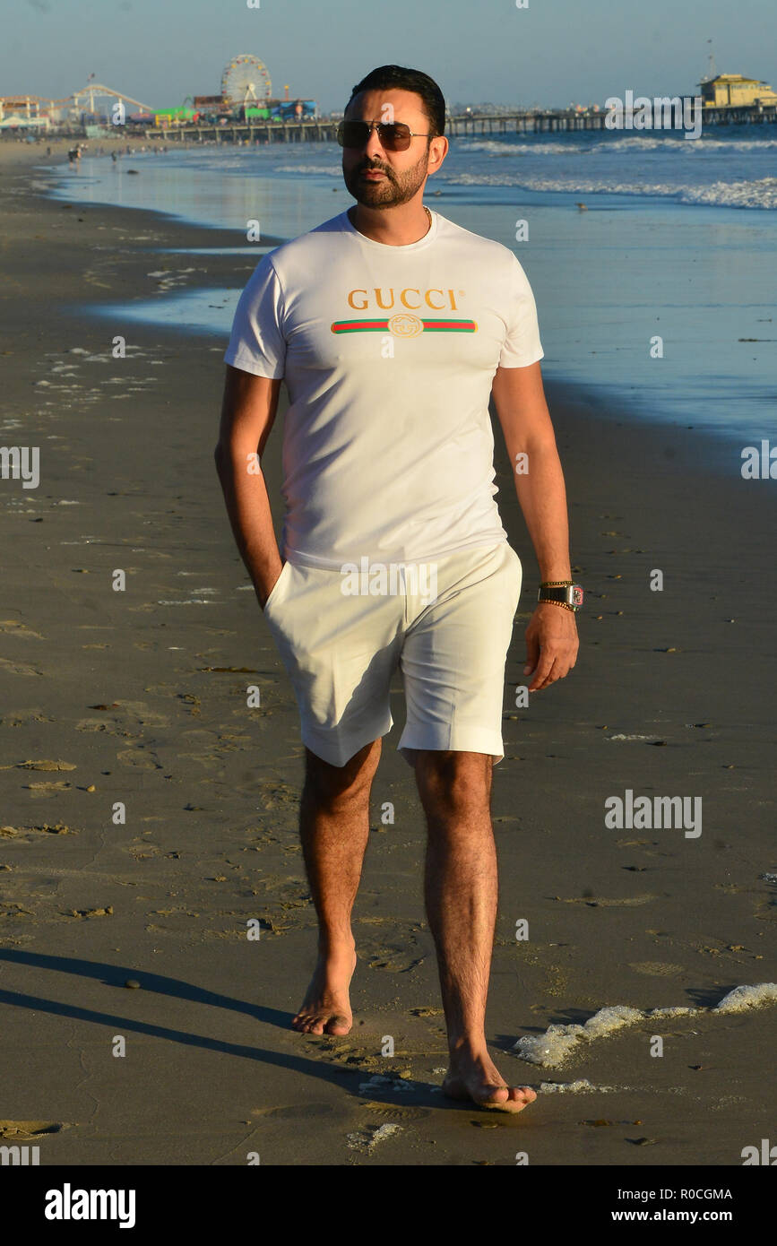 Mohamed Karim going for a walk on Santa Monica beach during some time ...