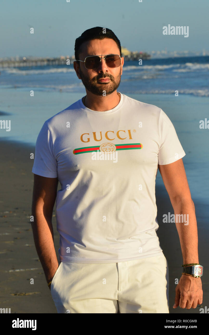 Mohamed Karim going for a walk on Santa Monica beach during some time ...