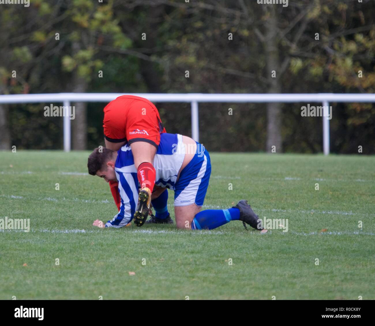 Football action from an amateur match between Whaley Bridge Athletic ...