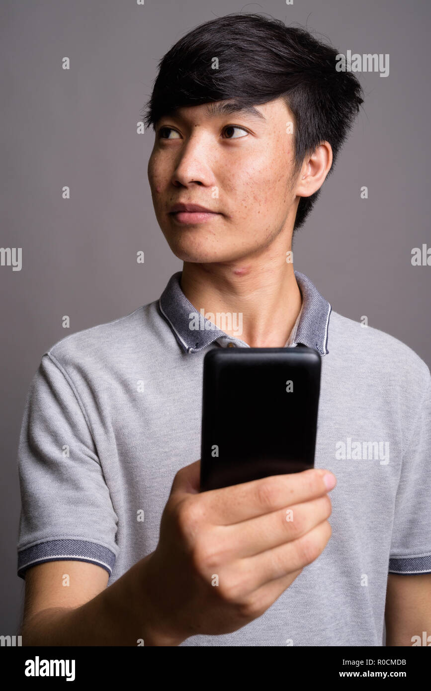 Asian man using mobile phone hi-res stock photography and images - Alamy