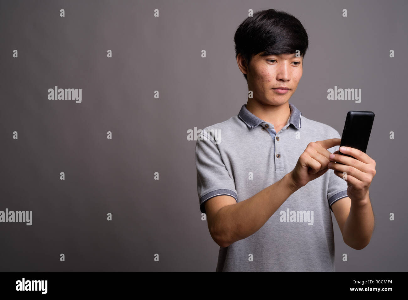 Asian man using mobile hi-res stock photography and images - Alamy