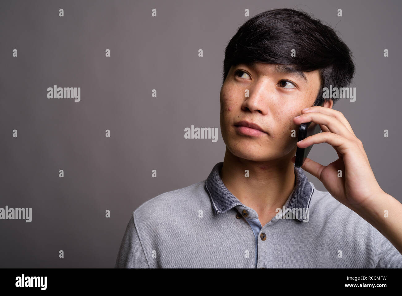 Asian man holding head hi-res stock photography and images - Alamy