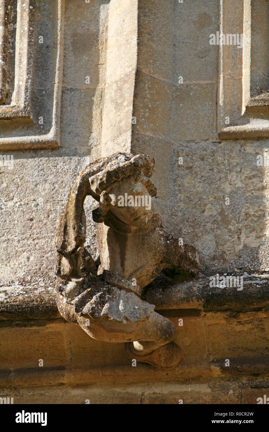 Carving of a boy in the act of climbing down from the parapet at ...