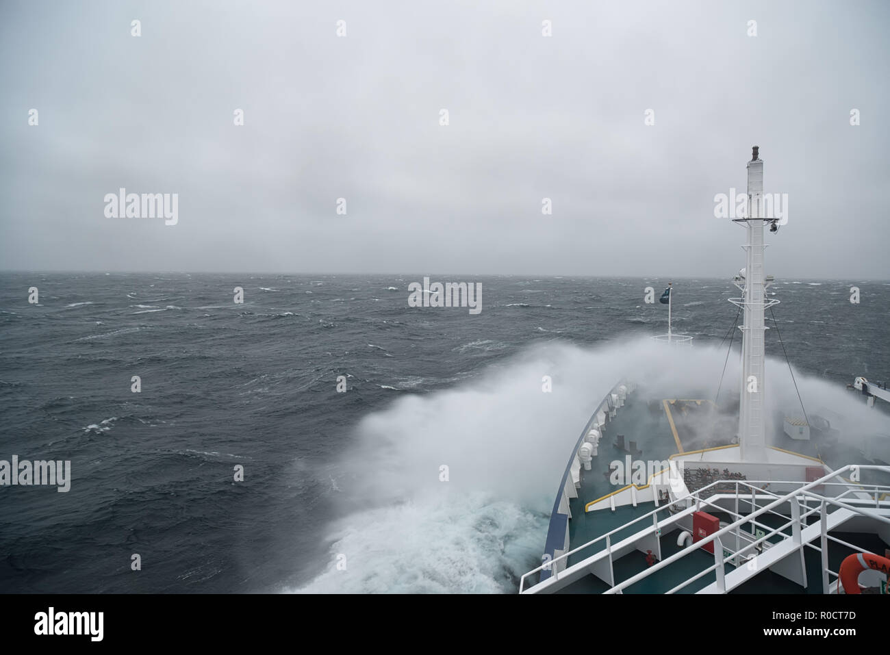 Ship cruising in storm and heavy seas crossing the Denmark Strait ...