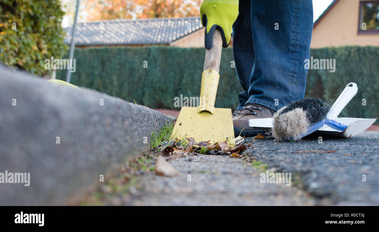 Man is cleaning the street gutter Stock Photo - Alamy