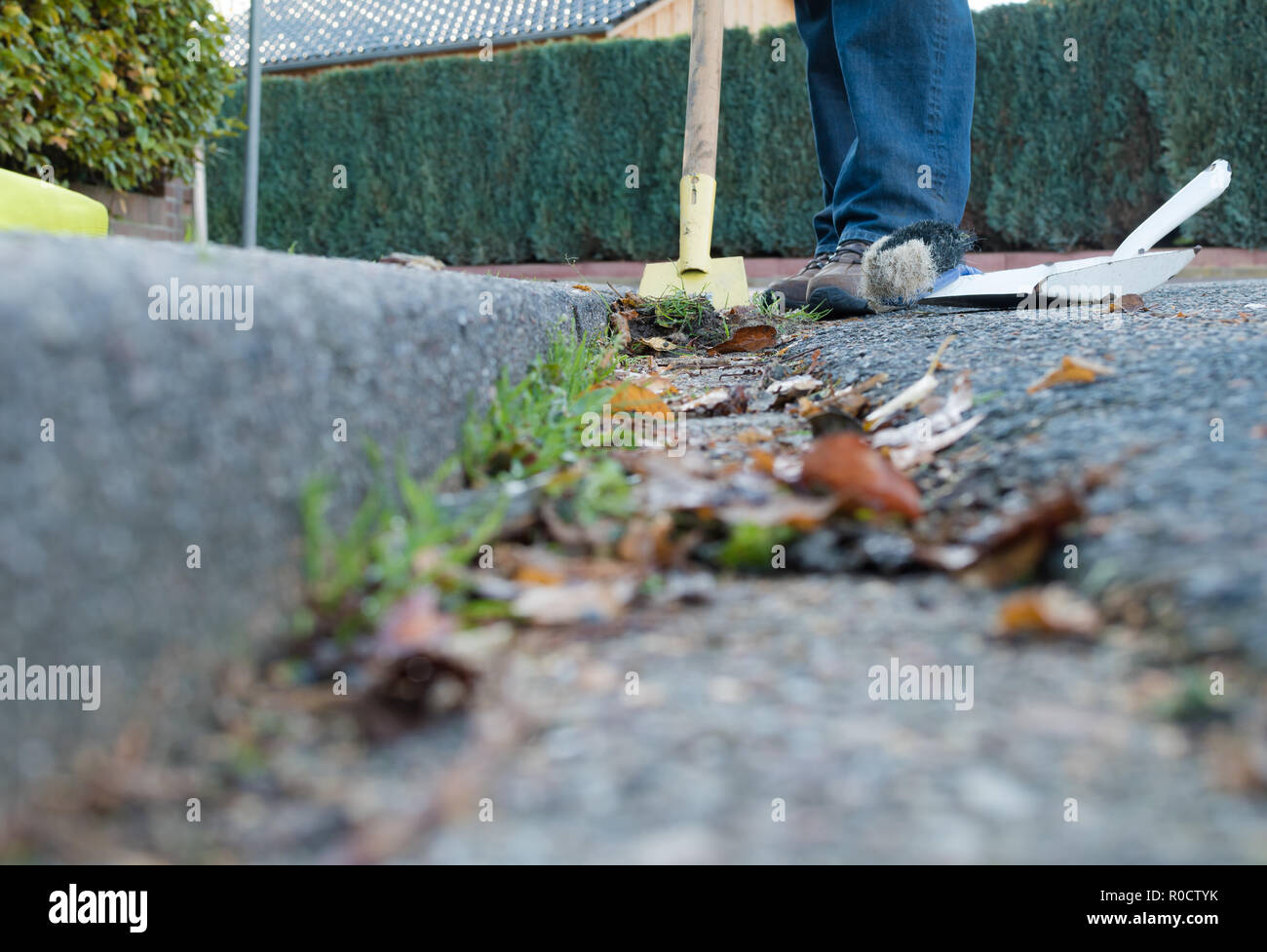 Man is cleaning the street gutter Stock Photo - Alamy