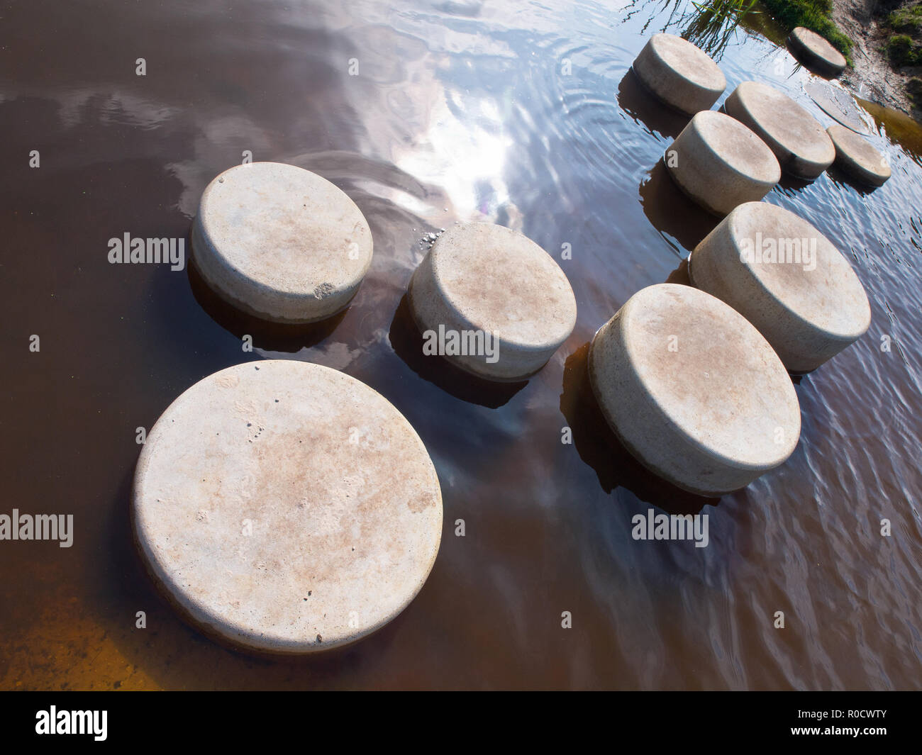 Stepping Stones in Water of a Pond Stock Photo - Alamy