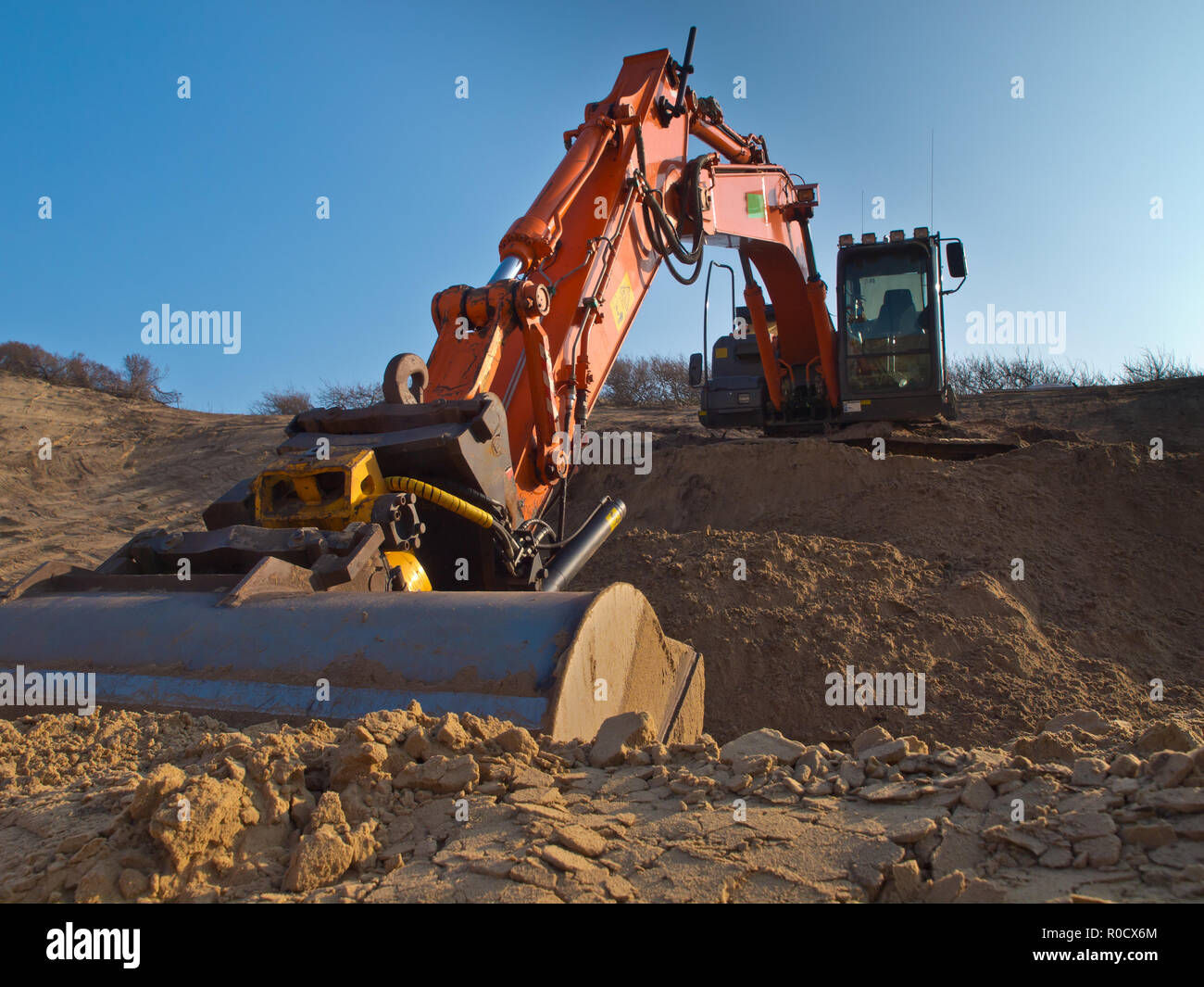 Orange colored heavy construction digger Stock Photo - Alamy