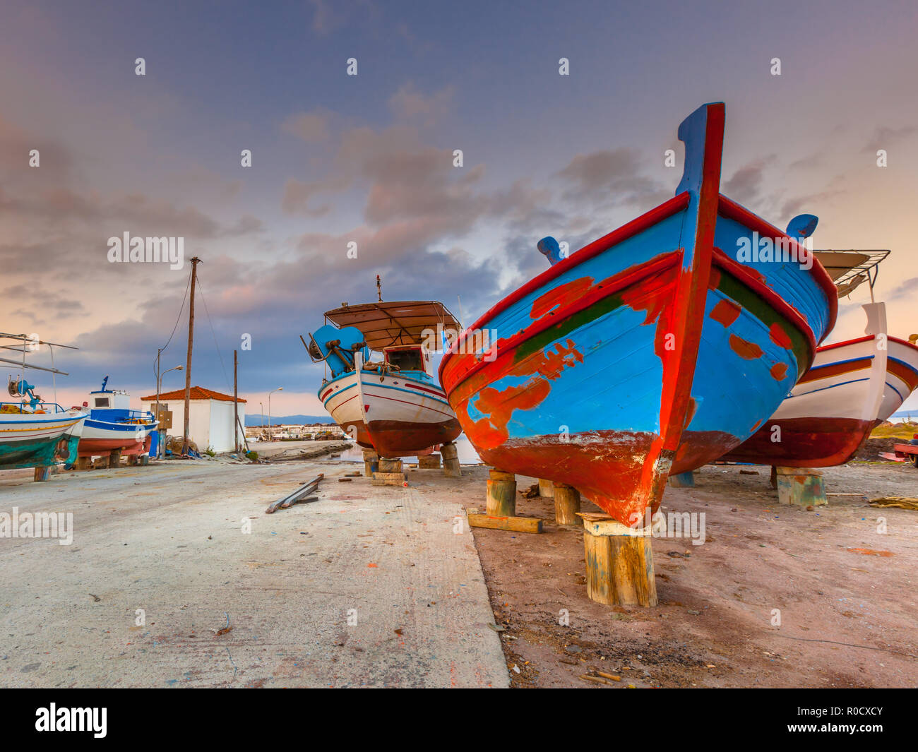 Greek harbor scene. Fishing boats being serviced in a traditional greek ...