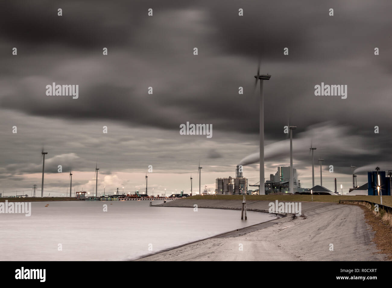 Long exposure image of Eemshaven harbor at sunset on a dark clouded day ...