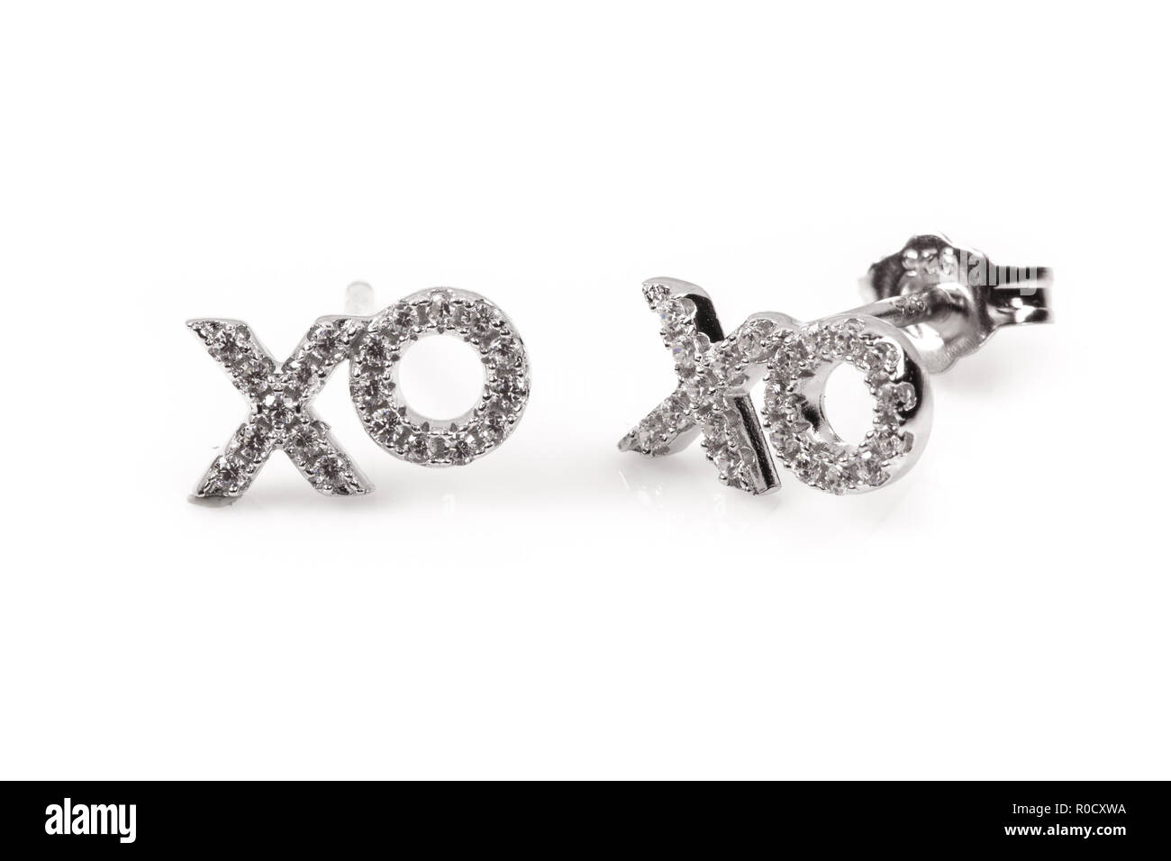 Silver hugs and kisses earrings isolated on white studio background ...