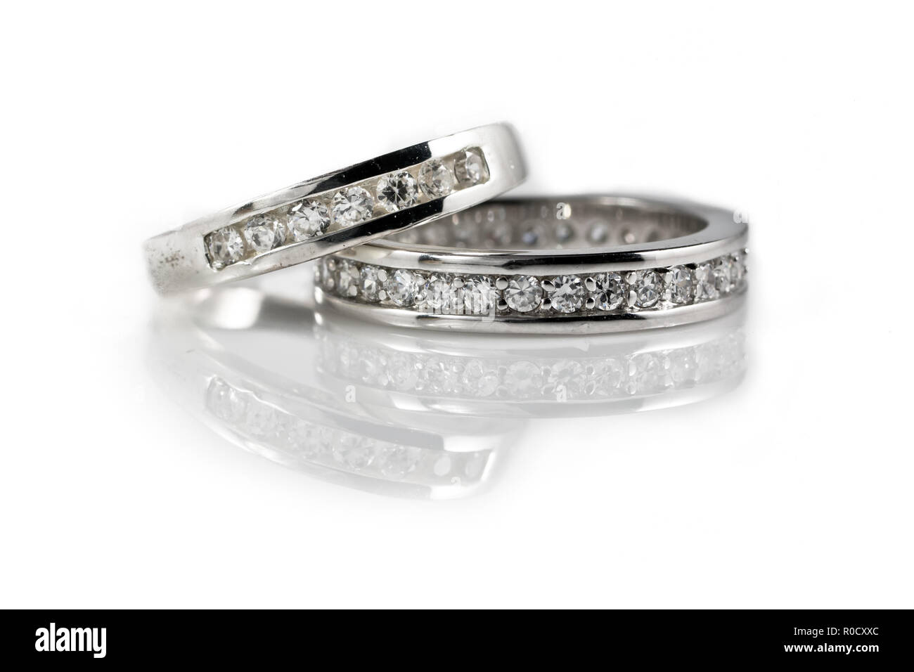 Two engagement rings with diamonds on white background Stock Photo - Alamy