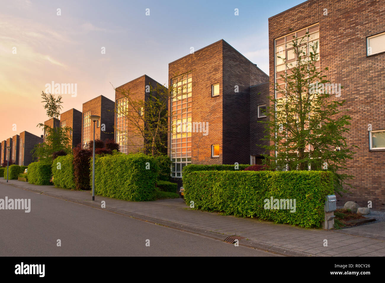 Street with modern houses in a suburban area Stock Photo - Alamy