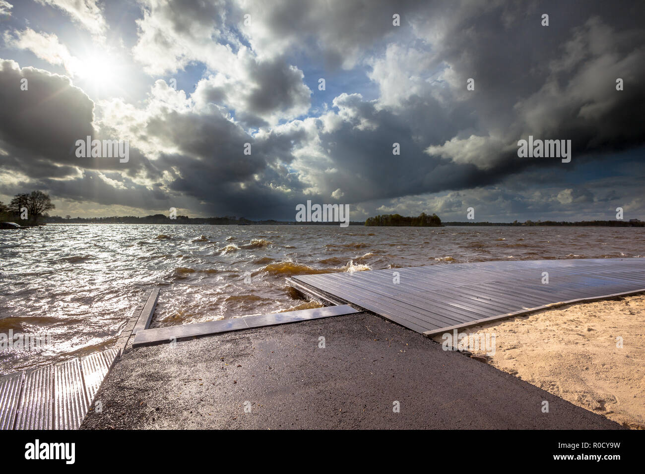 Strong wind dark clouds and moderate high waves breaking on a landing ...