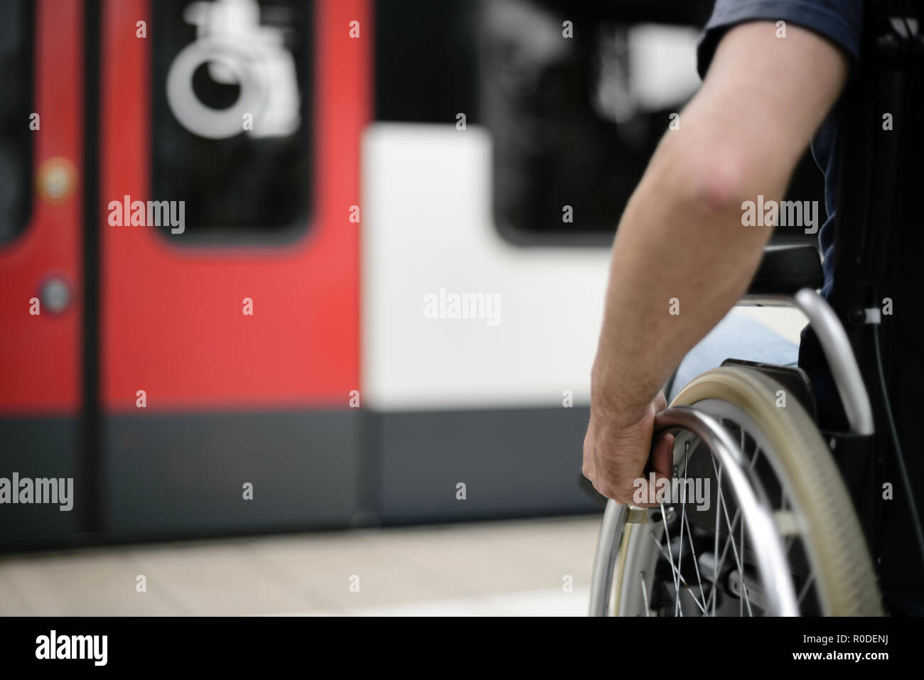 Wheel chair user on platform station in front of train metro ...