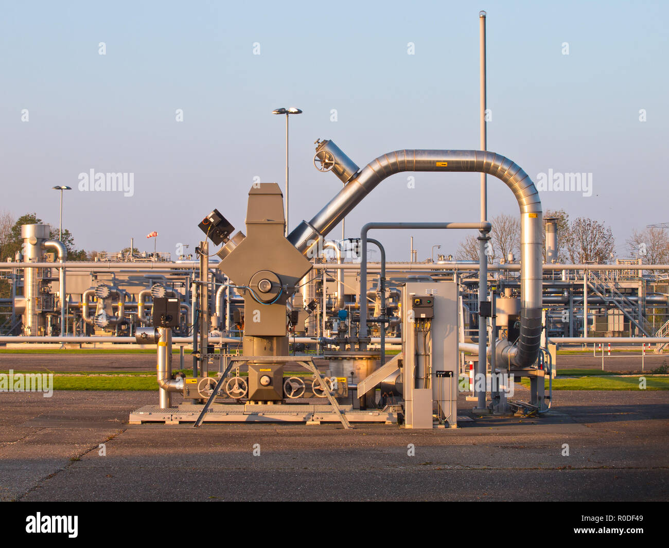 Natural gas well processing plant backdrop during sunset Stock Photo ...