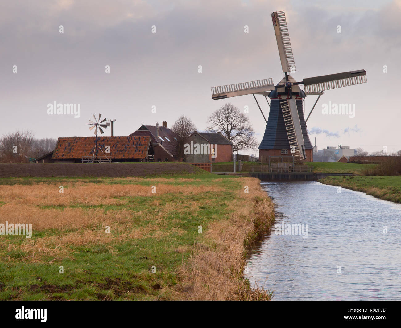 Traditional dutch windmill in polder landscape Stock Photo - Alamy